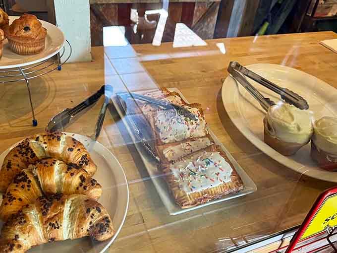 Fresh pastries waiting patiently behind glass, tempting you to add just one more thing to your already substantial order.