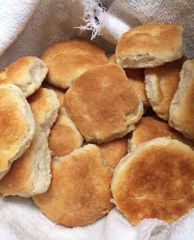 Fresh biscuits piled high like fluffy clouds of buttery heaven waiting to be devoured immediately.