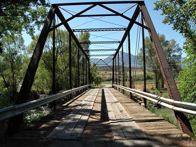 This weathered iron bridge has seen a century of seasons pass, and it's still the most photogenic crossing in the valley.