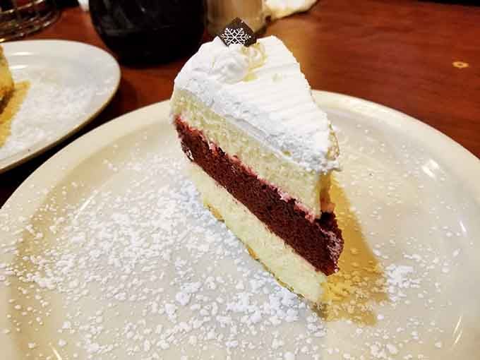 Layers of red velvet and cream cheese frosting dusted with powdered sugar, this slice is practically wearing a tuxedo.