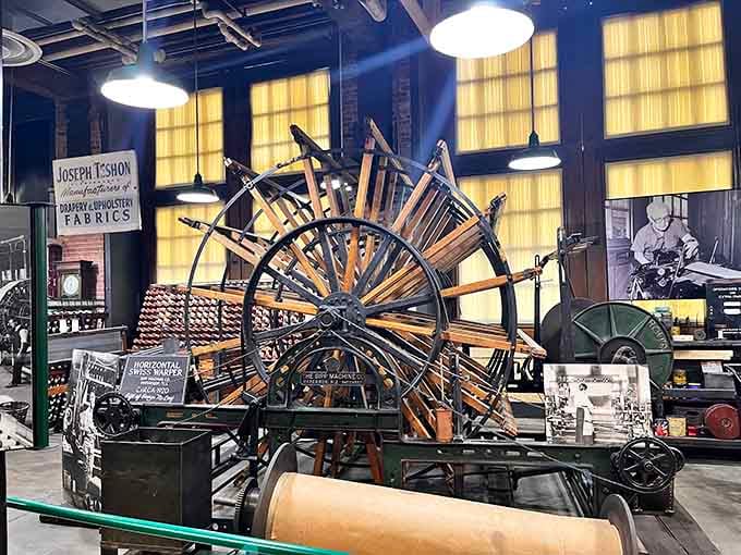 The Horizontal Swiss Warper fills the room with wooden spokes and golden mill light, looking like industrial art you can actually touch.