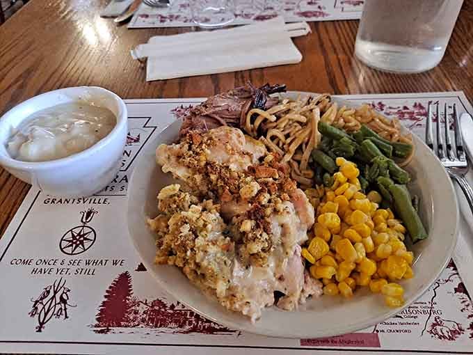 A plate so loaded with casserole, noodles, corn, and green beans that your eyes and stomach need a moment to negotiate.