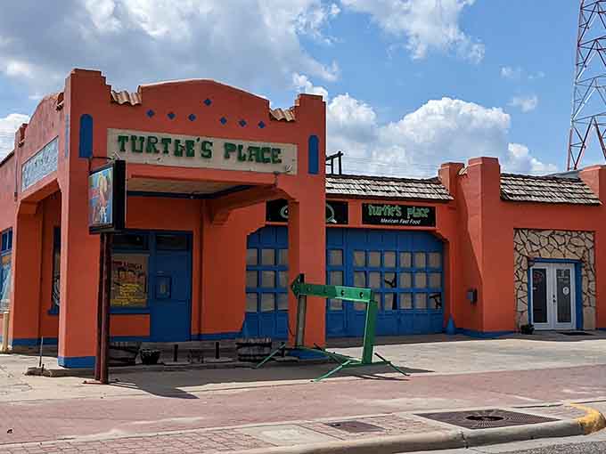 Turtle's Place brings serious color to the Panhandle with its vivid orange walls and bold blue doors, looking like a fiesta decided to become architecture.