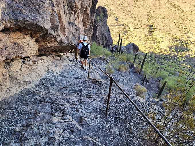 Steel cables bolted into ancient rock, because sometimes the best views require a little negotiation with gravity.
