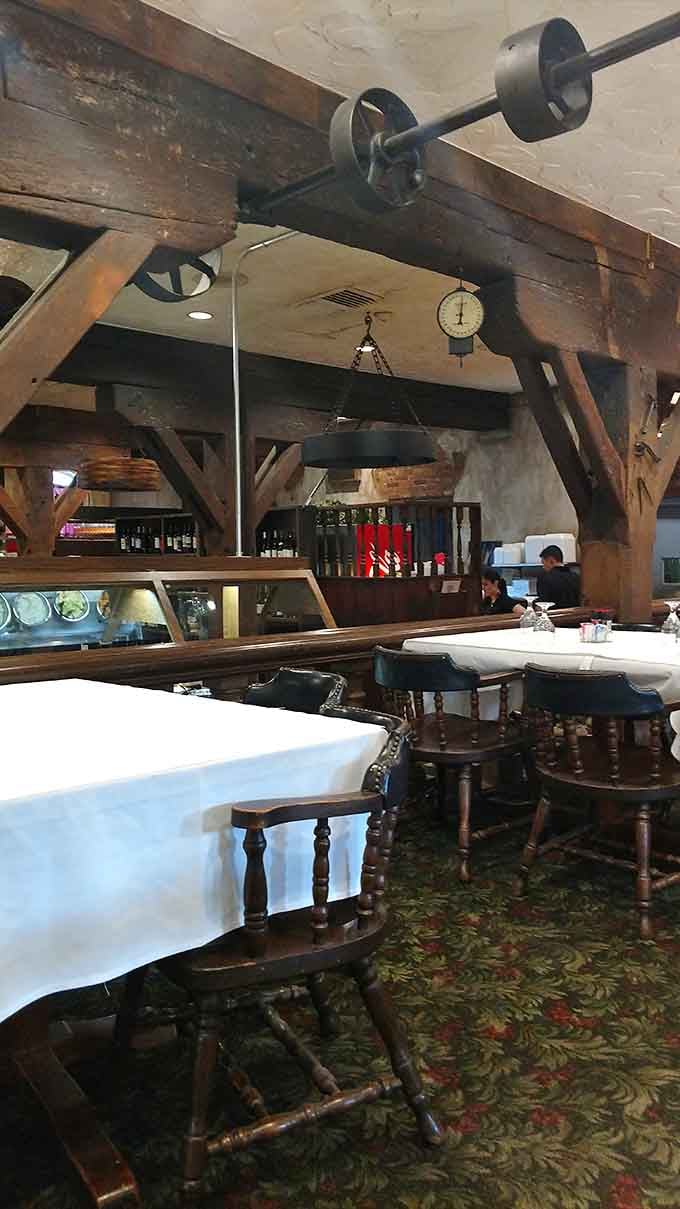 Original mill machinery still hanging overhead while diners enjoy dinner below. That's not decor, that's genuine Ohio character.