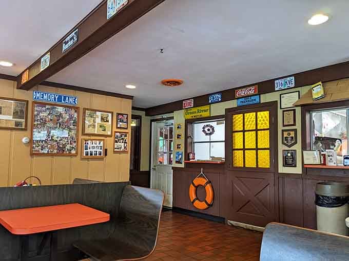 More license plates, a "Memory Lane" sign, and a life preserver. The Port decorates with personality.
