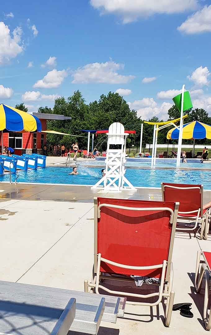 Red lounge chairs, striped umbrellas, and a lifeguard tower standing tall. Portland Water Park's pool deck is summer in its purest form.