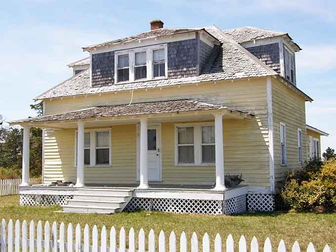 That yellow porch and peeling paint tell three centuries of coastal stories without saying a single word.