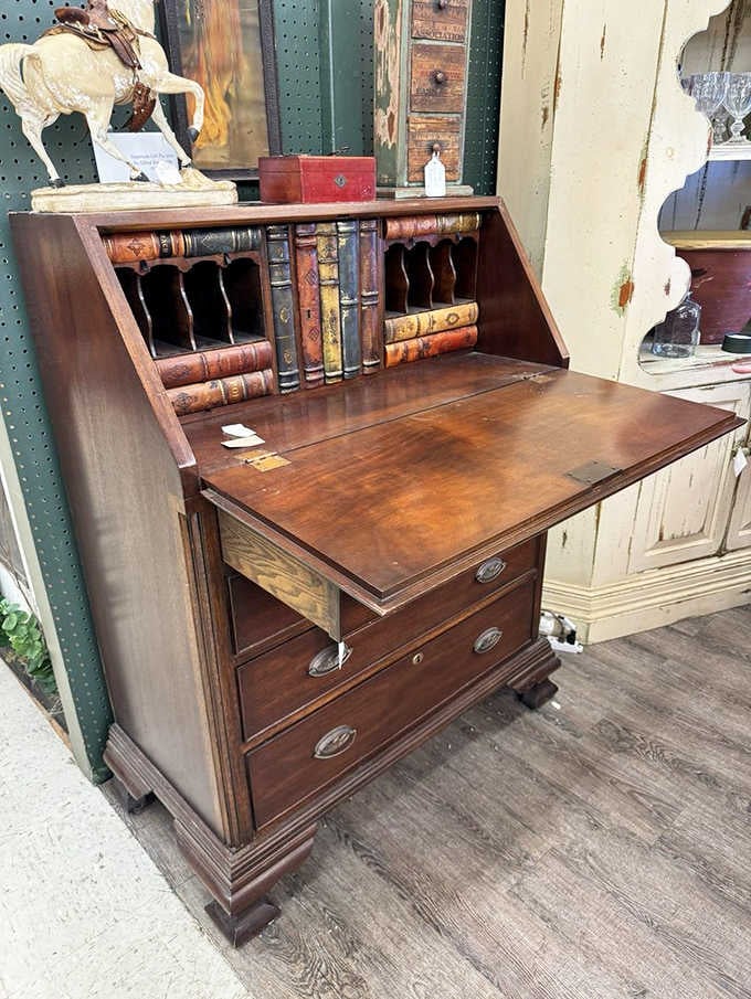 A classic drop-front bureau desk with original hardware. Somebody wrote important letters at this thing, and it shows.