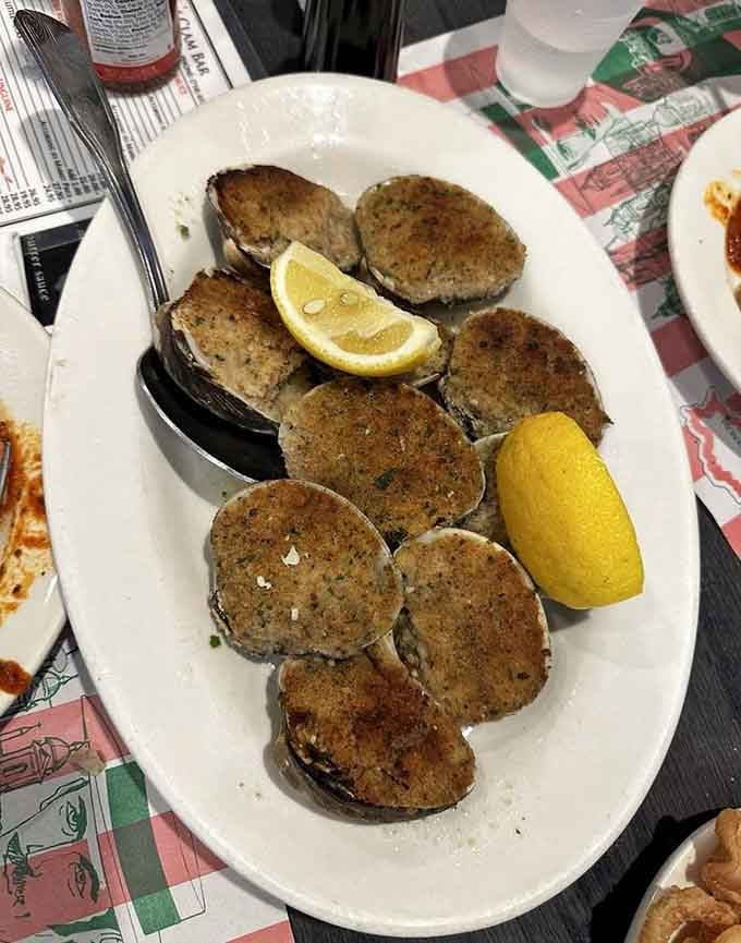 Baked clams lined up on a white oval platter with lemon wedges, this is Brooklyn's version of a standing ovation.