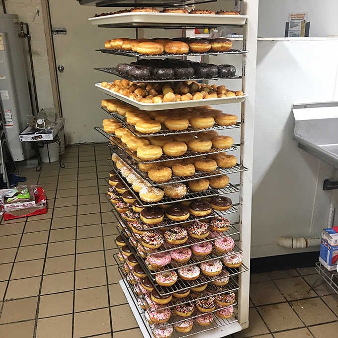That towering rack of fresh donuts represents more morning joy than a double rainbow over a field of puppies playing.
