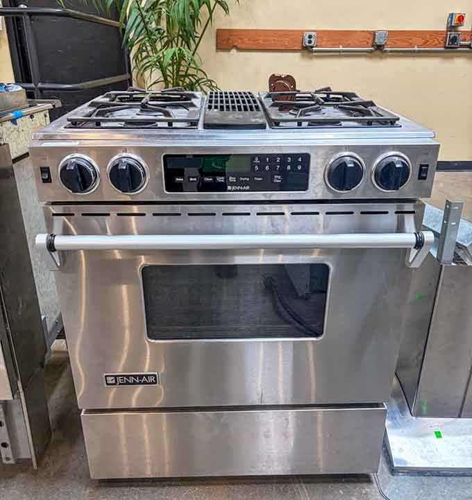 A stainless Jenn-Air gas range that clearly has more cooking left to do, sitting here at a fraction of its original cost.