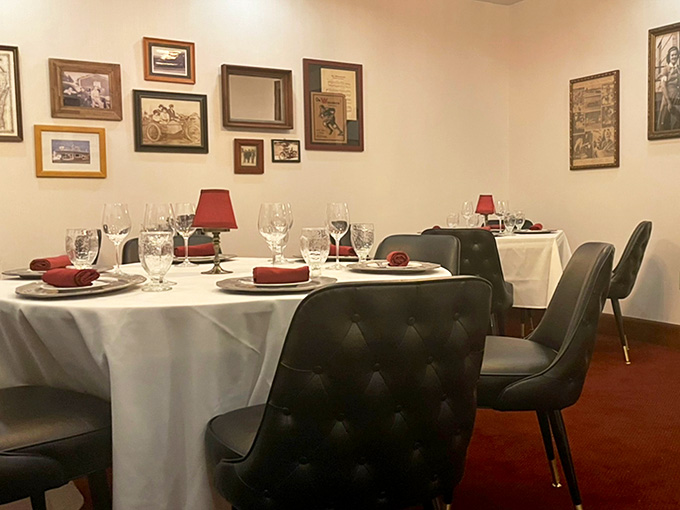 A private dining room covered in framed history, where every wall tells a story worth leaning in to hear.