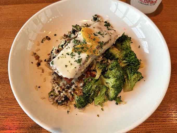 Perfectly plated fish over rice with roasted broccoli, this dish looks like it belongs in a much fancier zip code.