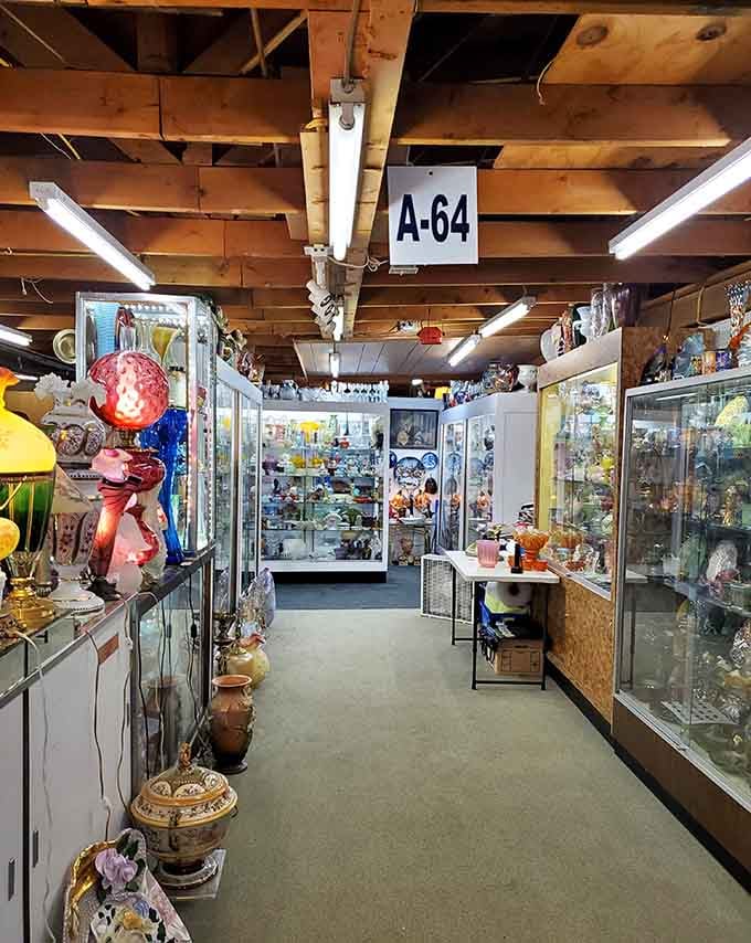 A long aisle of illuminated glass cases stretches ahead, packed with colorful art glass that practically glows.