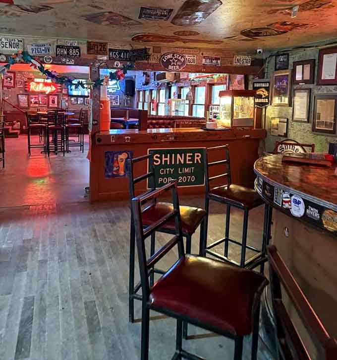 License plates, Lone Star signs, and a Shiner City Limit marker. Every wall here tells a different Texas story.