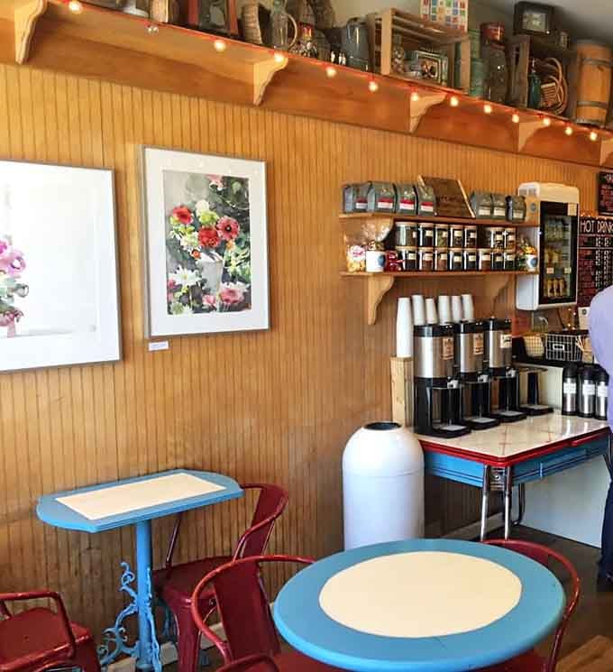 Blue caf&eacute; tables, warm wood walls, and local artwork hanging nearby, this corner of the shop feels like a Hudson Valley hug.