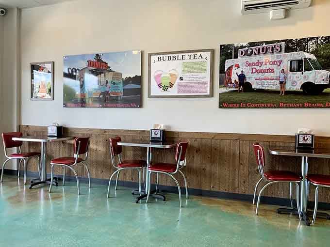Retro red chairs, teal floors, and photos of the Sandy Pony food truck on the wall. Pure charm.