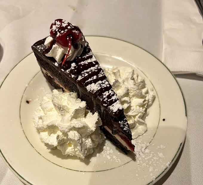Black Forest Cake piled high with whipped cream and cherries. This dessert is not shy, and neither should you be.