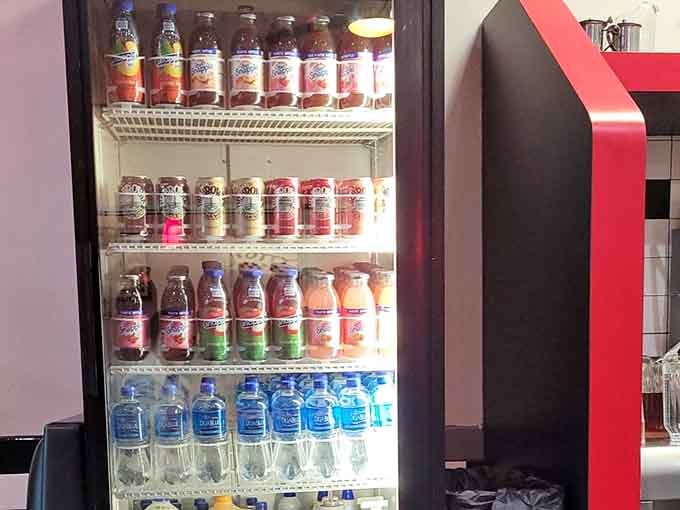 A refrigerator stocked with colorful bottled drinks, because Scotty's believes your beverage deserves as much thought as your meal.