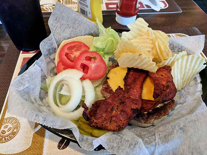 A proper bacon cheeseburger with all the toppings, served in a basket like it owns the place. Respect.