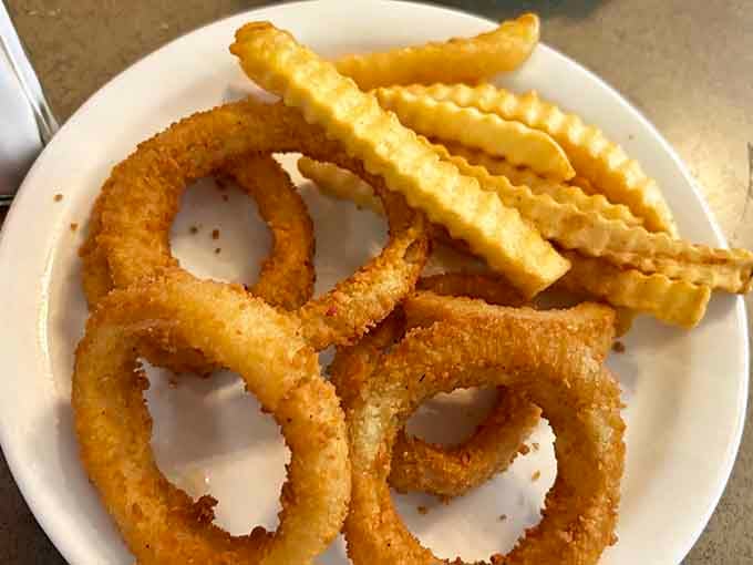 Crunchy onion rings and crinkle-cut fries, because a legendary sandwich deserves legendary company on the plate.