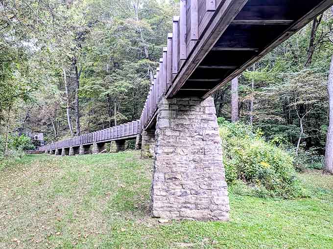 Massive limestone pillars hold up a wooden flume bridge, engineering from another era that still refuses to quit.