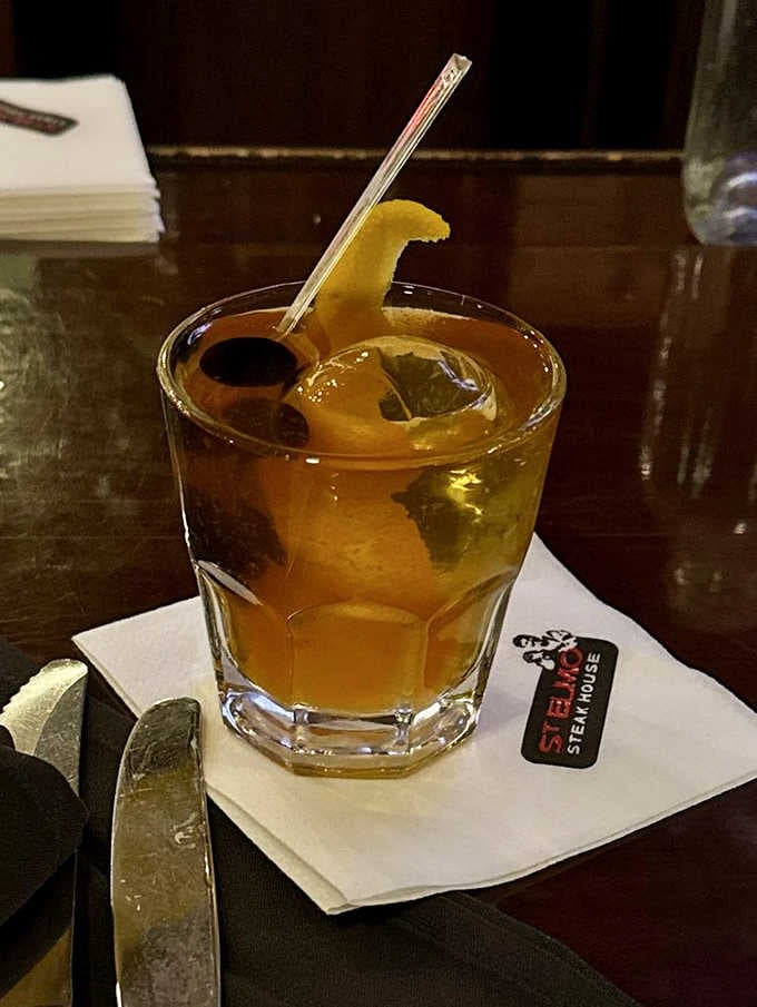 A proper Old Fashioned on a St. Elmo napkin, the kind of drink that slows the whole evening down.