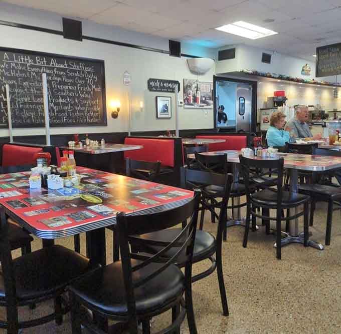 Red booths, retro tabletops, and a chalkboard wall telling Steffens' story. Every detail here earns its place.