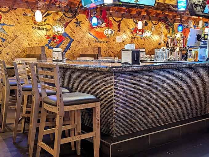 A bar area covered in hand-drawn maps and colorful decor. This is where good conversations and great drinks find each other.