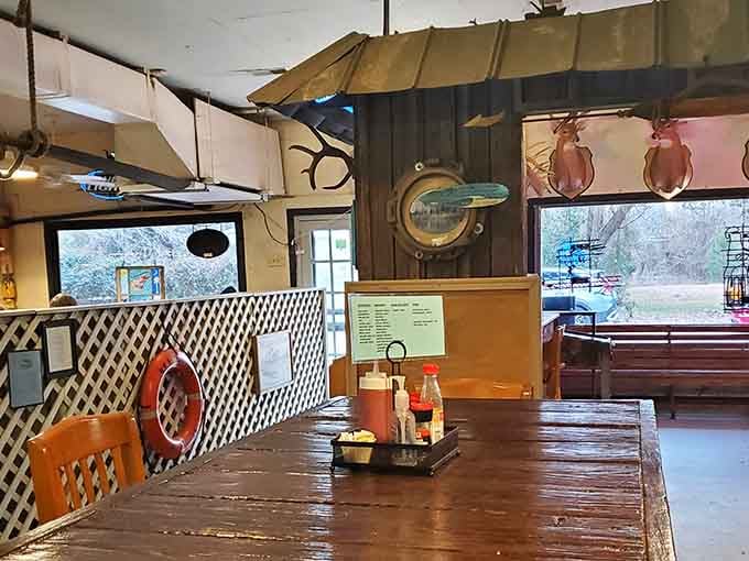 A porthole window, mounted antlers, and a life ring from Charleston, because why choose one theme when you can have them all?