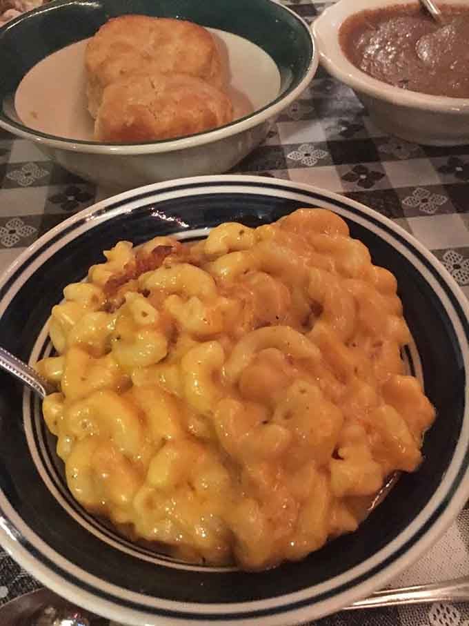 Baked mac and cheese with a golden crust, served alongside fresh biscuits. Comfort food doesn't get more honest than this.