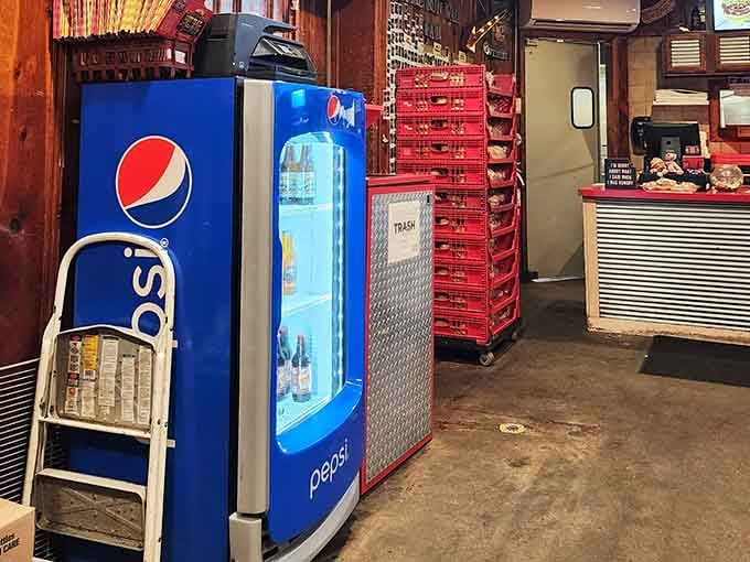 A Pepsi fridge, stacked red crates, and a counter that means business. Honest, no-frills, and completely charming.
