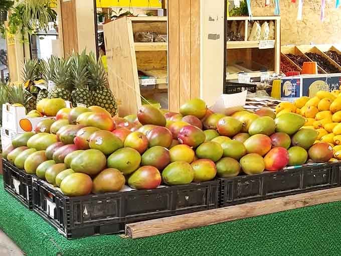 A mountain of ripe, jewel-toned mangoes sitting front and center, this fruit display is basically sunshine you can hold in both hands.