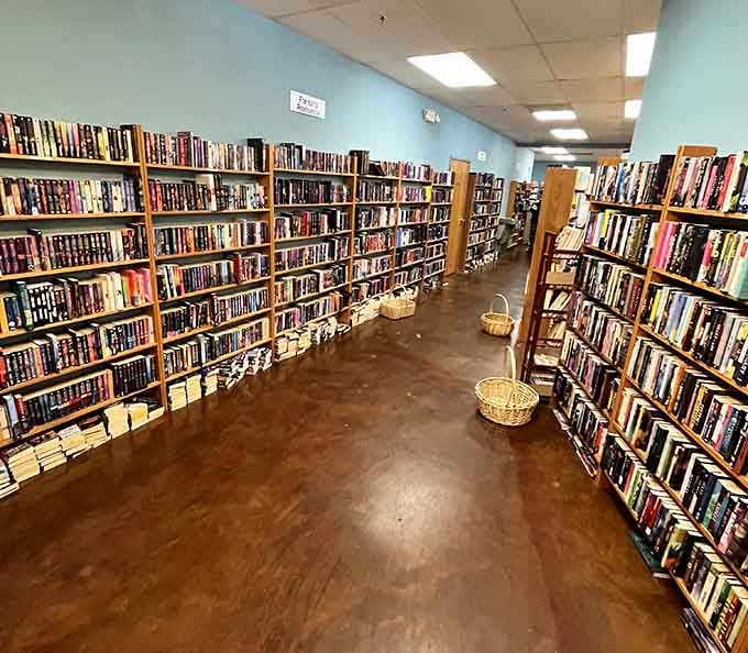 Two long walls of fiction stretching into the distance, with wicker baskets on the floor just waiting to be filled.
