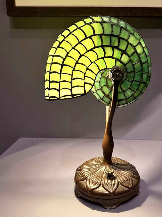 That nautilus shell lamp in luminous yellow-green glass proves Tiffany looked at the ocean and thought, "Yes, but make it glow from within."