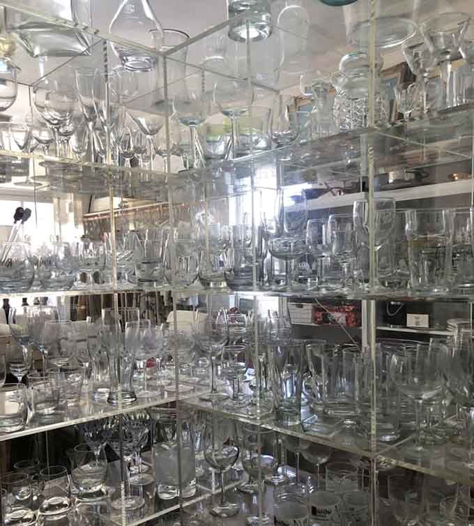 Shelf after shelf of glassware catching the light, proof that someone in Palm Beach entertained very, very well.