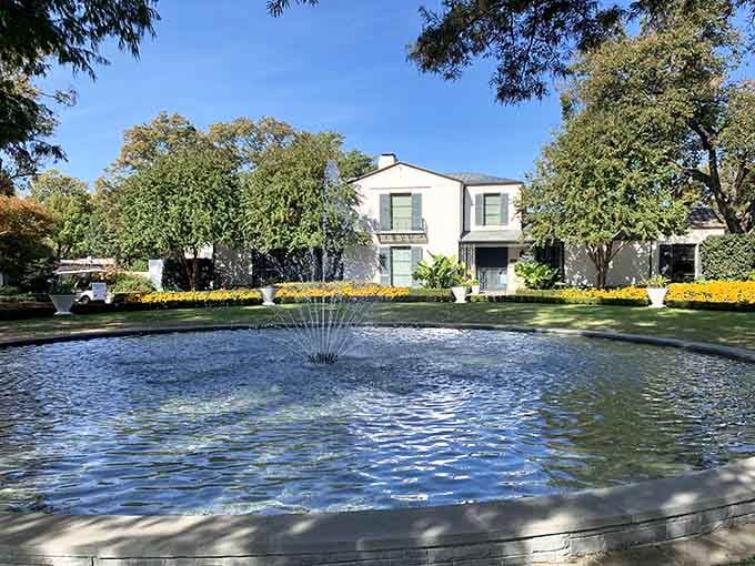 A classic fountain anchors the elegant historic home behind it, timeless and quietly impressive all at once.