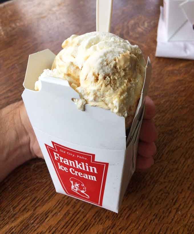 Pale golden honeycomb ice cream spilling over its little box, the kind of scoop that makes you forget your own name.