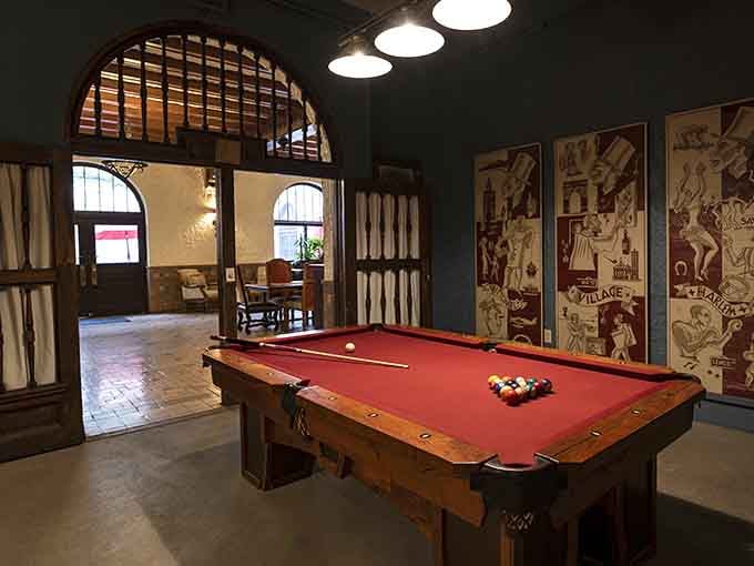 A red felt pool table under arched windows. Even the billiard room here looks like it belongs in a museum.