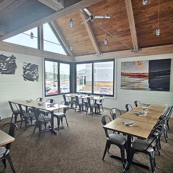 Vaulted wood ceilings, nautical pendant lights, and waterfront art. This room tells a story worth sitting down for.