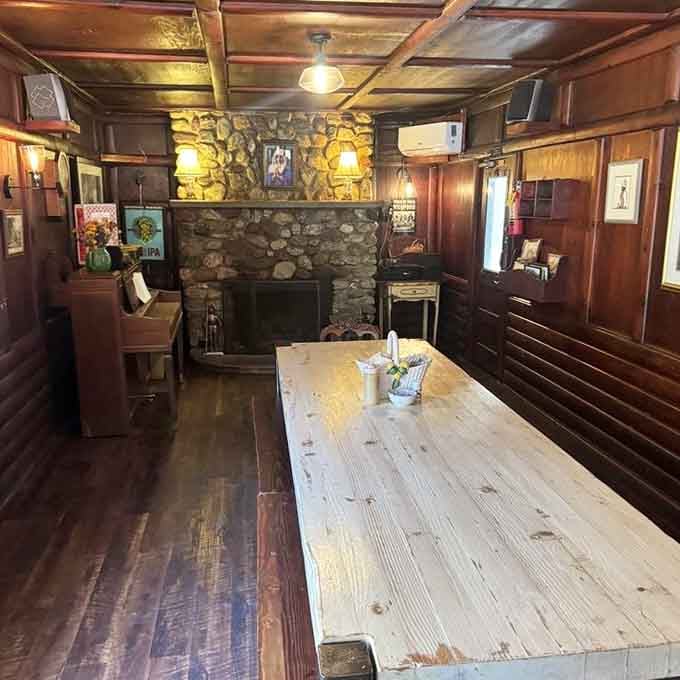 Stone fireplace, wood paneling, and long communal tables, this dining room feels like your favorite uncle's house.