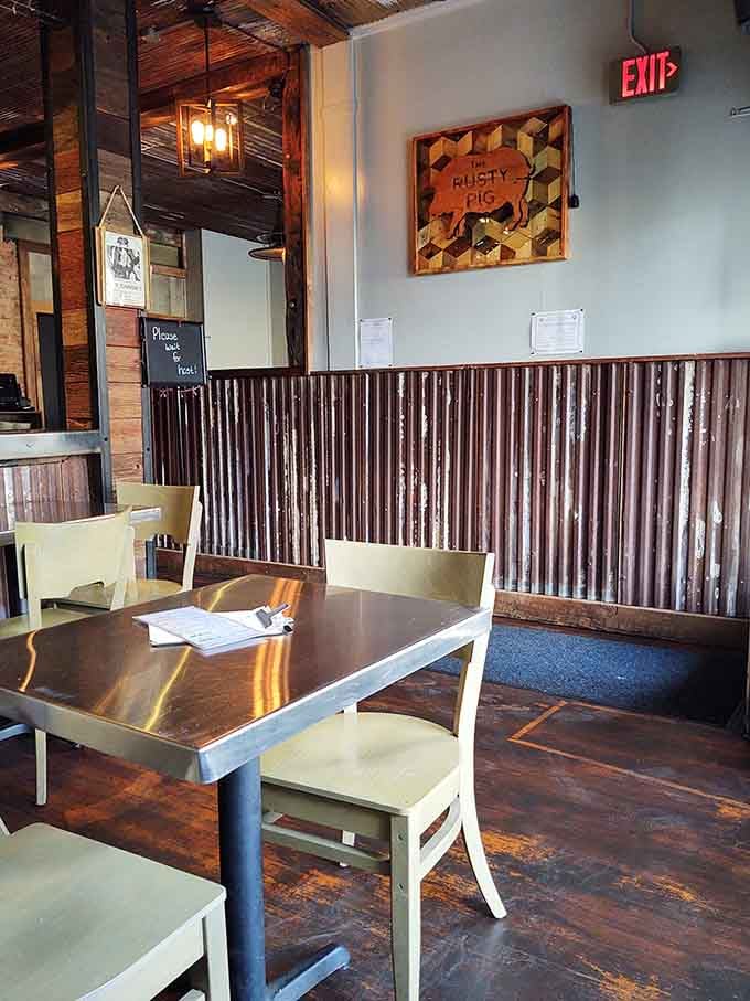 Corrugated metal walls, warm wood tones, and a Rusty Pig sign that feels right at home up there.