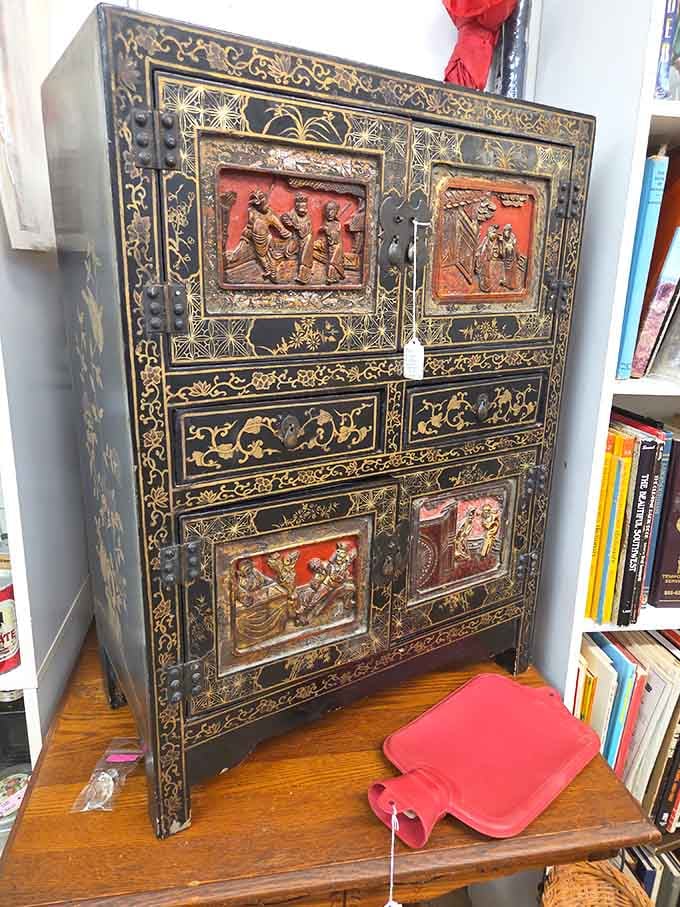 This ornate lacquered cabinet covered in gold detail and carved scenes is the kind of piece that stops you cold.