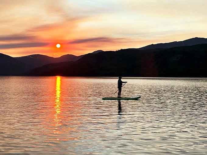 One paddleboarder, one blazing sunset, and a sky so dramatic it looks like nature hired a cinematographer.
