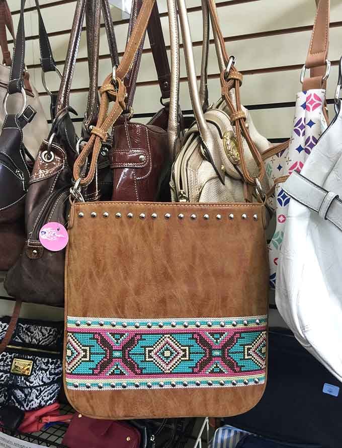 A studded crossbody bag with bold geometric embroidery front and center, the kind of find that makes you do a double take.