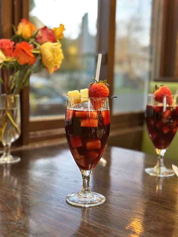 Sangria Tr&oacute;pica dressed up with fresh fruit and a straw, looking like a vacation you didn't know you needed.