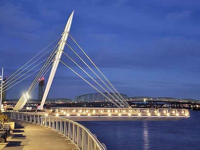 The pedestrian bridge lit up at night turns the whole waterfront into something that belongs on a postcard.