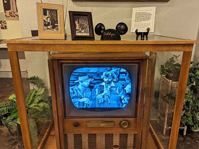 A vintage television playing classic Disney footage, topped with a personalized Mickey ear hat. Nostalgia just reached critical levels.