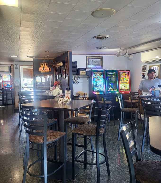 Glowing gaming machines, fish art on the walls, and bar-height tables built for long, comfortable evenings.
